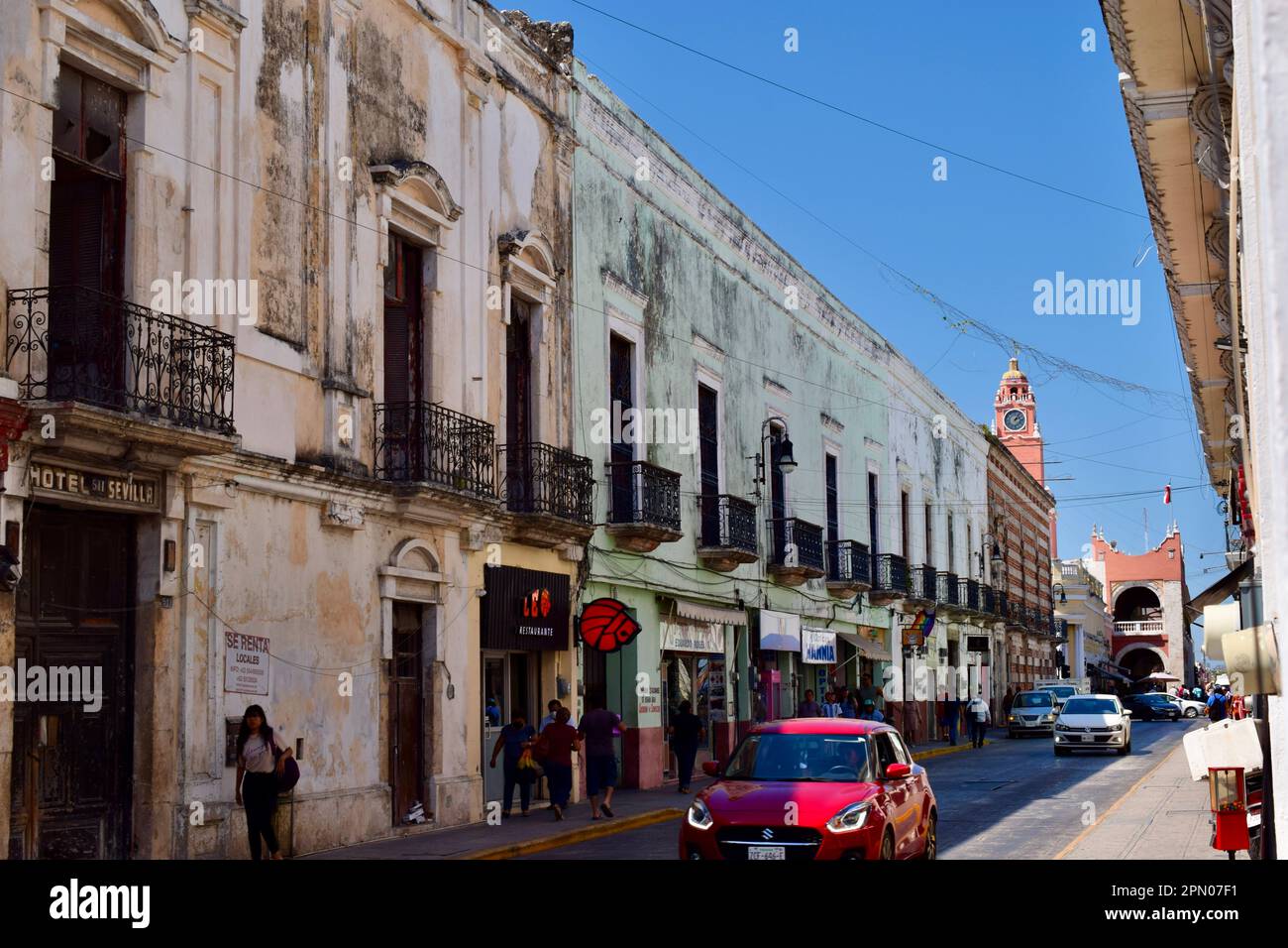 A street with colonial buildings in the historic city of Merida ...