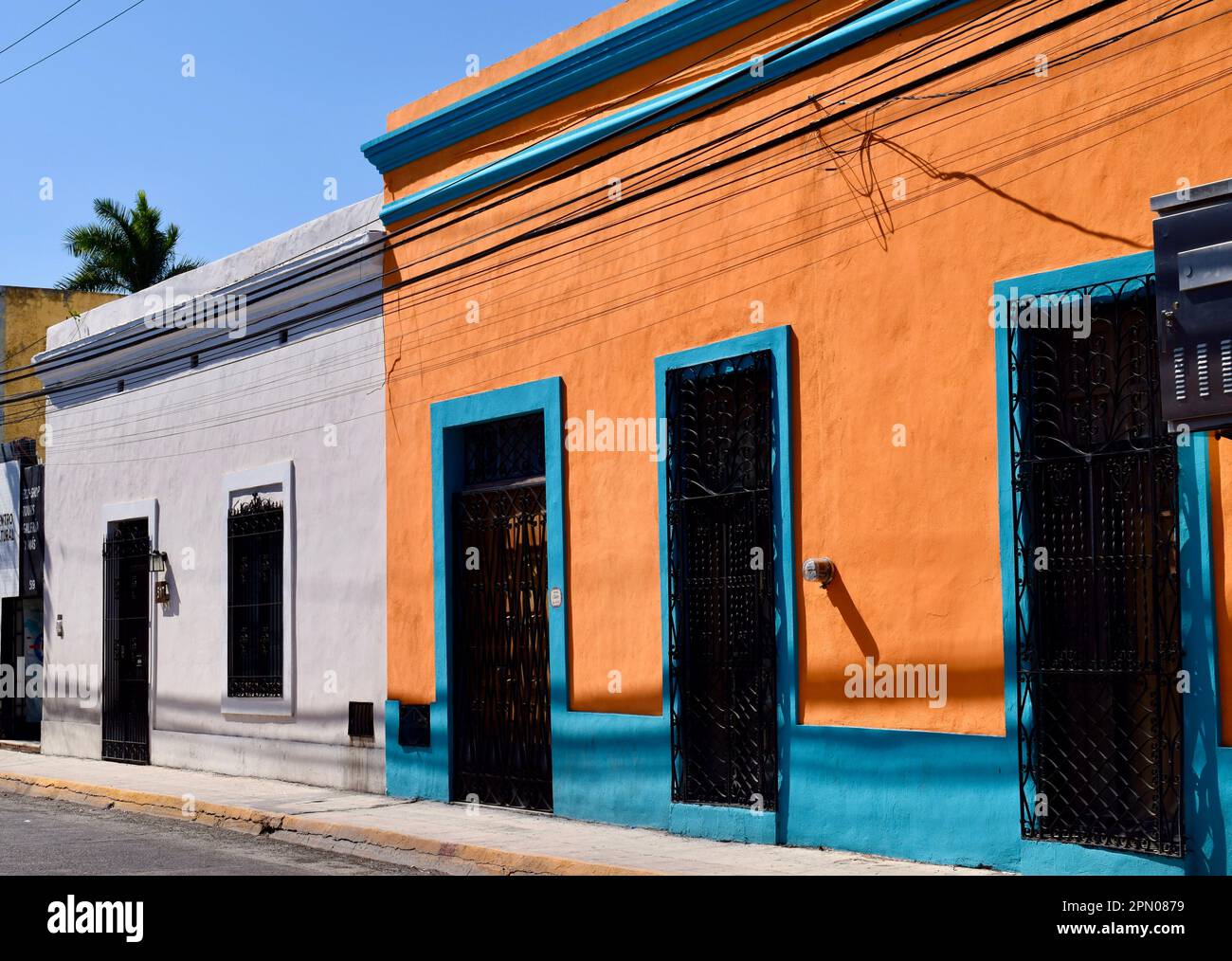 The beautiful facades of restored buildings in a street of Merida ...