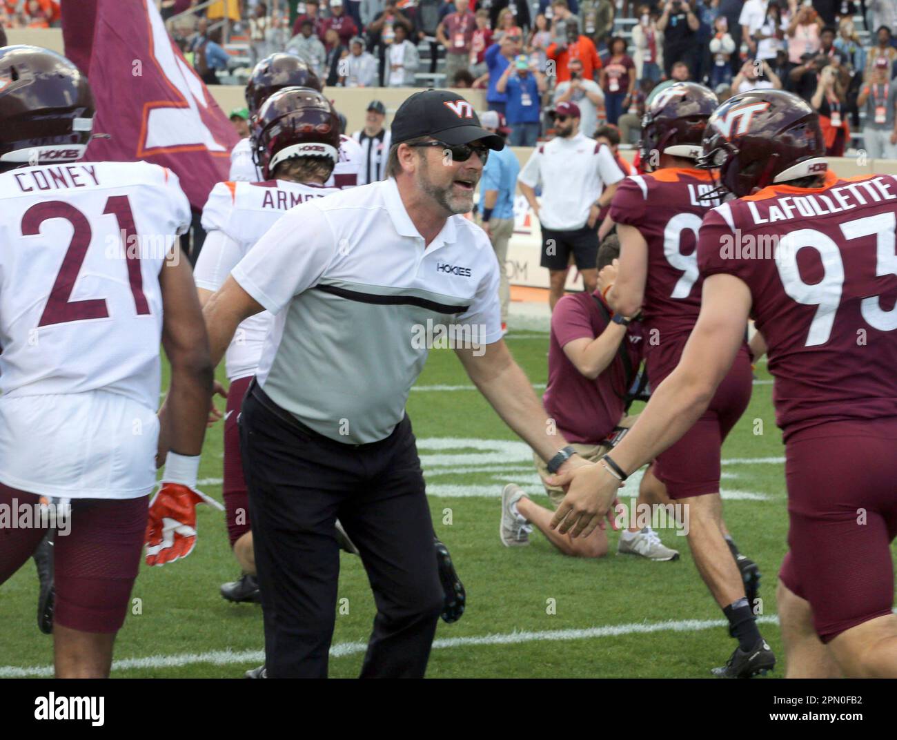 Virginia Tech head coach Brent Pry greets players as they take the ...