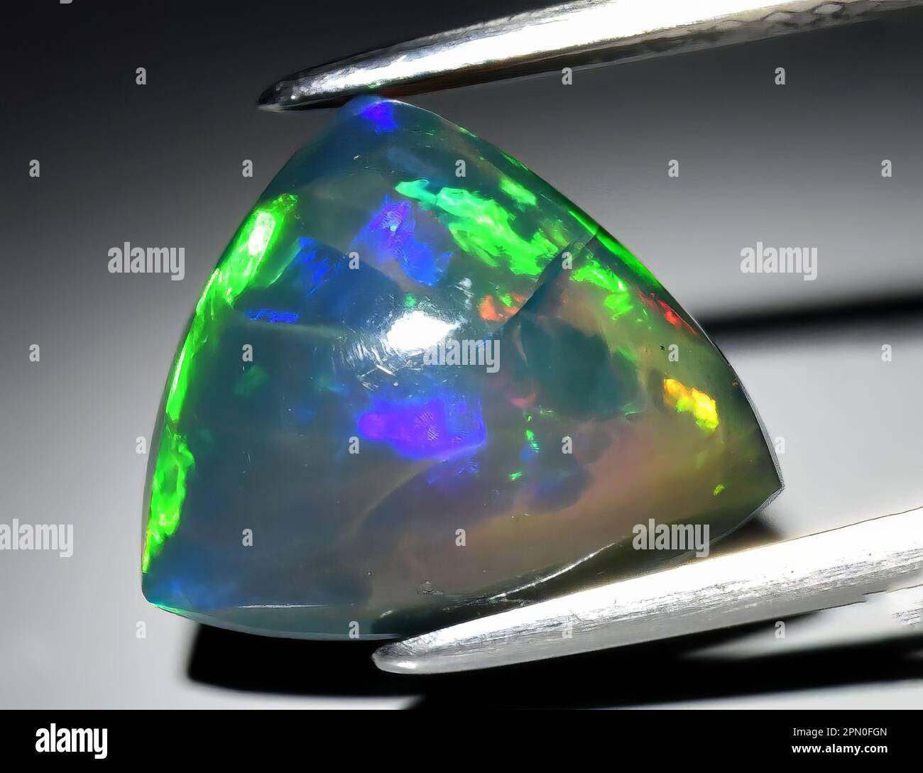 Natural precious stone noble opal on a black background Stock Photo - Alamy