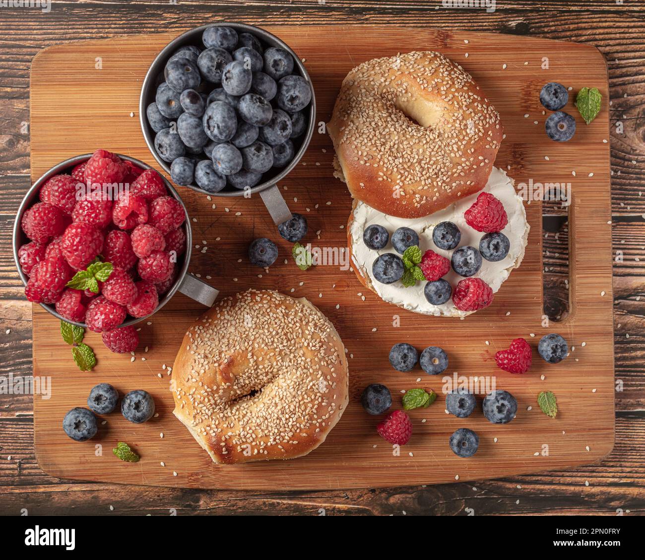 breakfast sesame bagel with cream-cheese and berries Stock Photo - Alamy