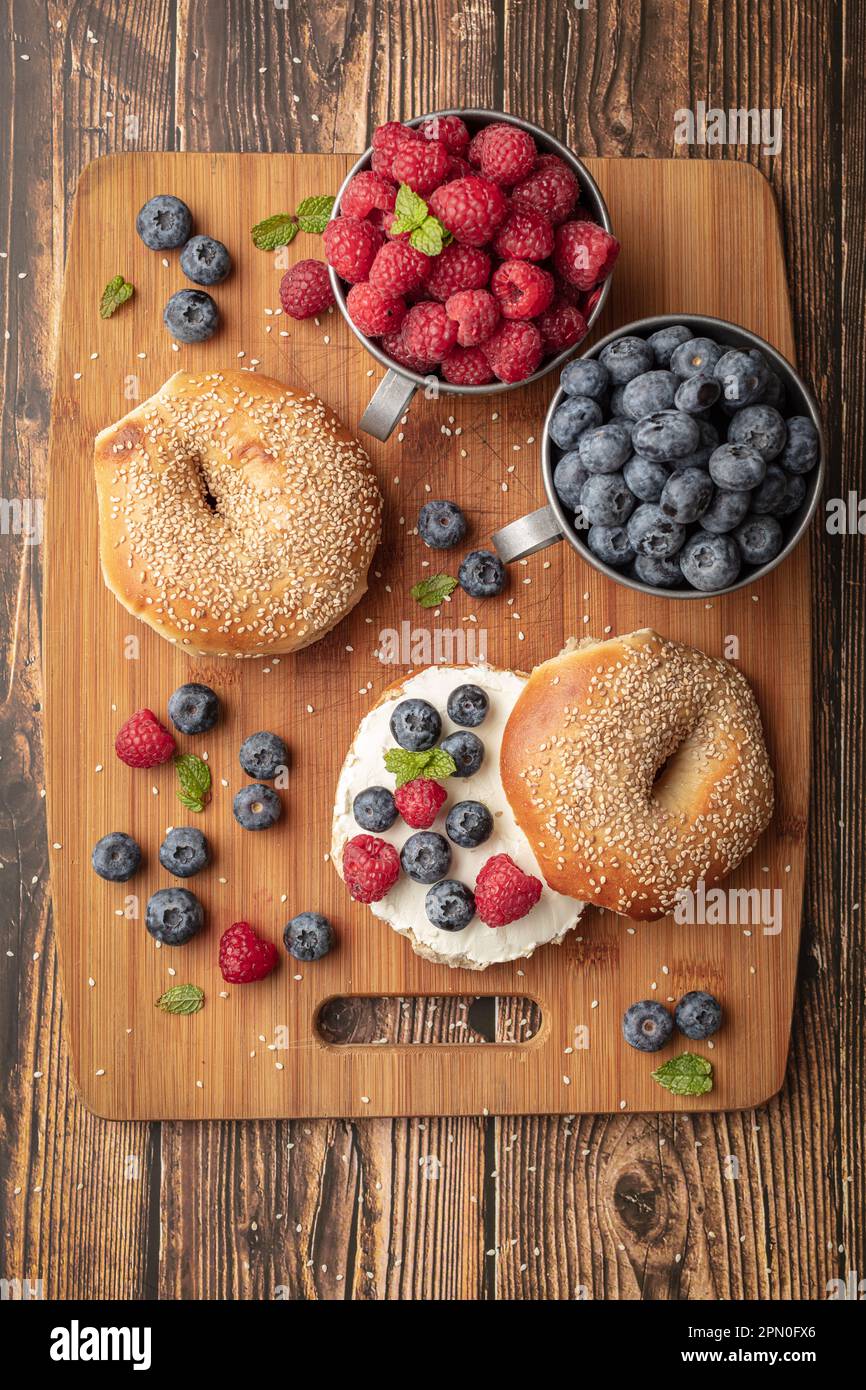 breakfast sesame bagel with cream-cheese and berries Stock Photo - Alamy