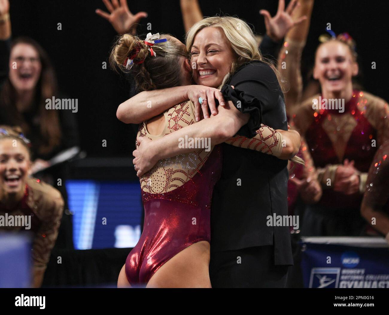 April 15, 2023: Oklahoma head coach K.J. Kindler hugs Audrey Davis ...
