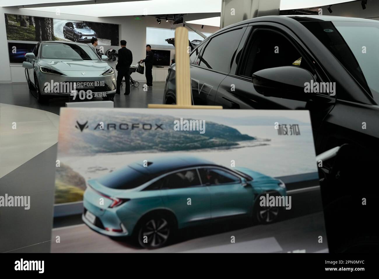 Visitors look at the Arcfox a-S, an all electric car from Chinese automaker BAIC which claims to ...
