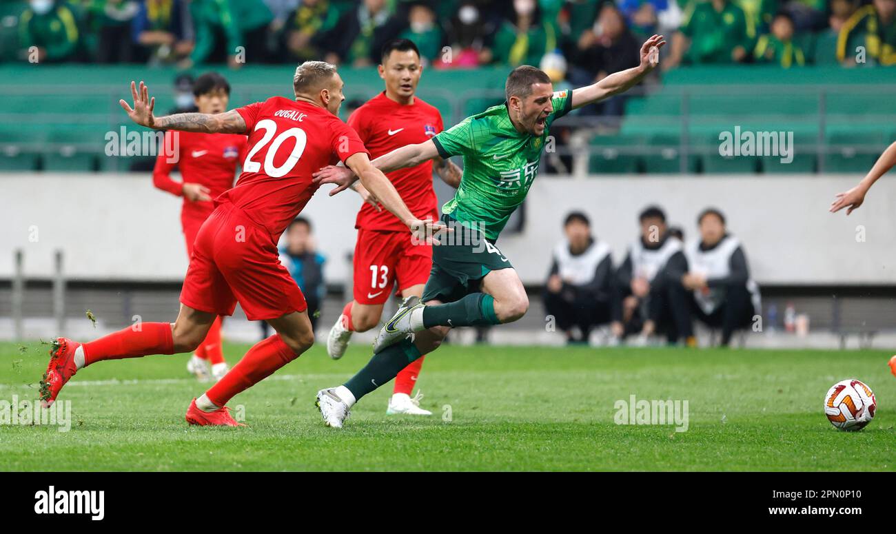Beijing, China. 15th Apr, 2023. Rade Dugalic (L) of Meizhou Hakka fouls ...