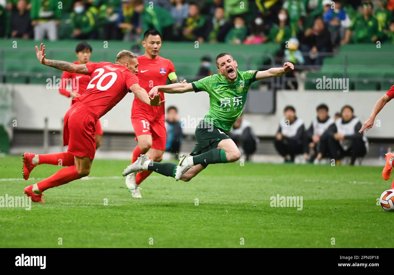 Beijing, China. 15th Apr, 2023. Rade Dugalic (L) of Meizhou Hakka fouls ...