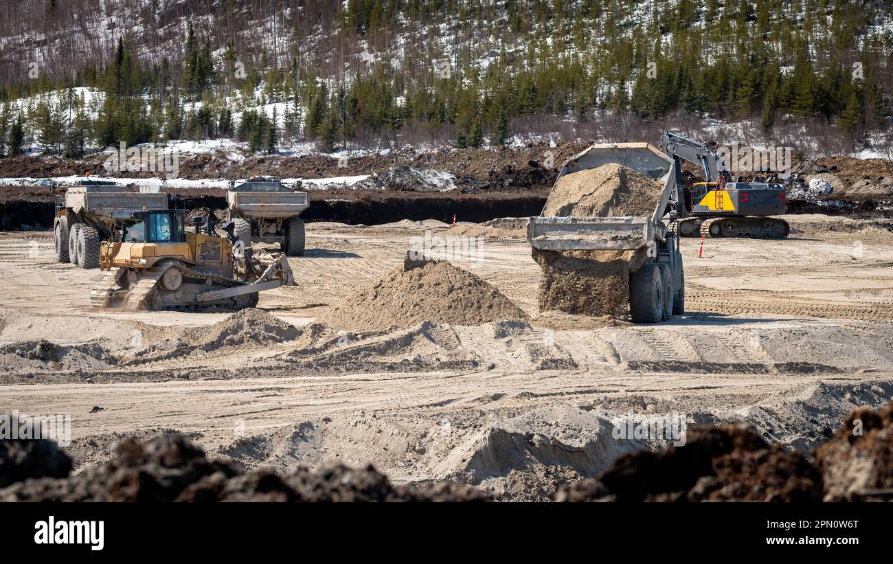 Backfilling works with dumpers and bulldozer for a mine tailings cell ...
