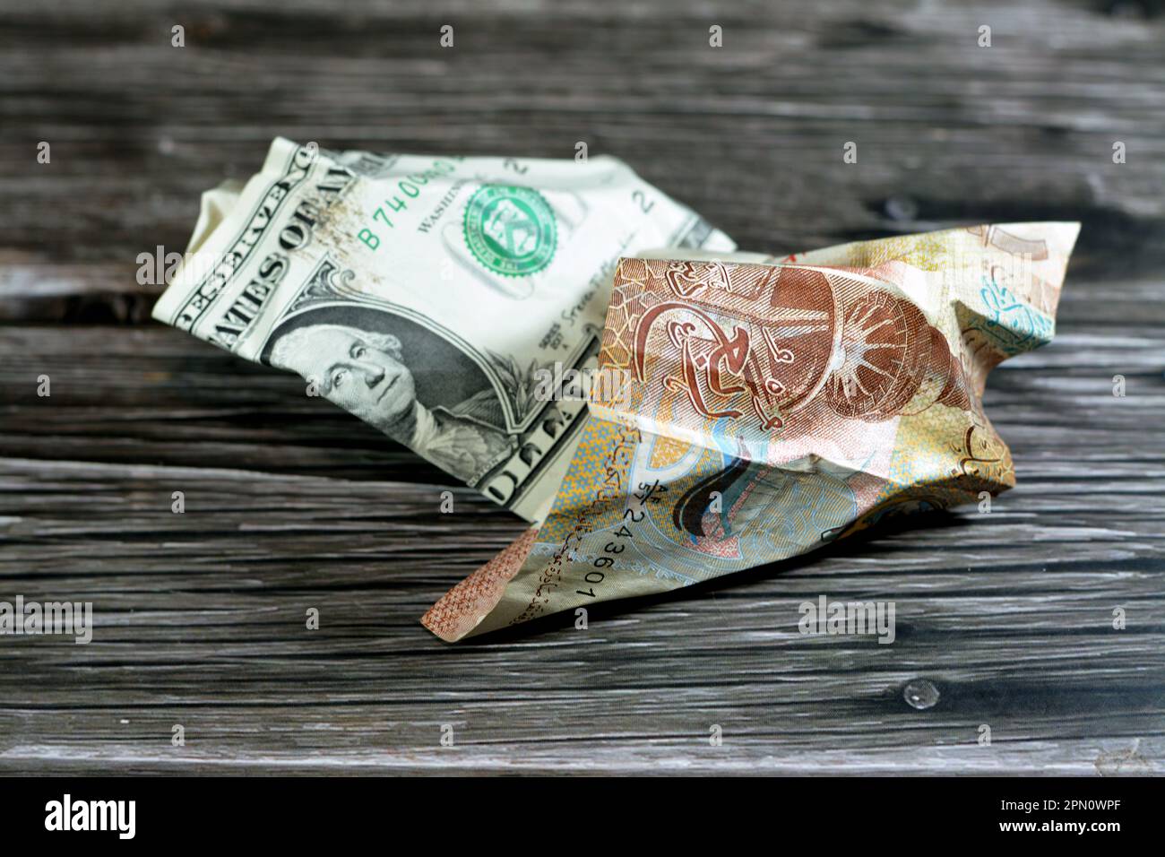 Money inflation and losing value, drop concept, Crumpled Kuwaiti money ...