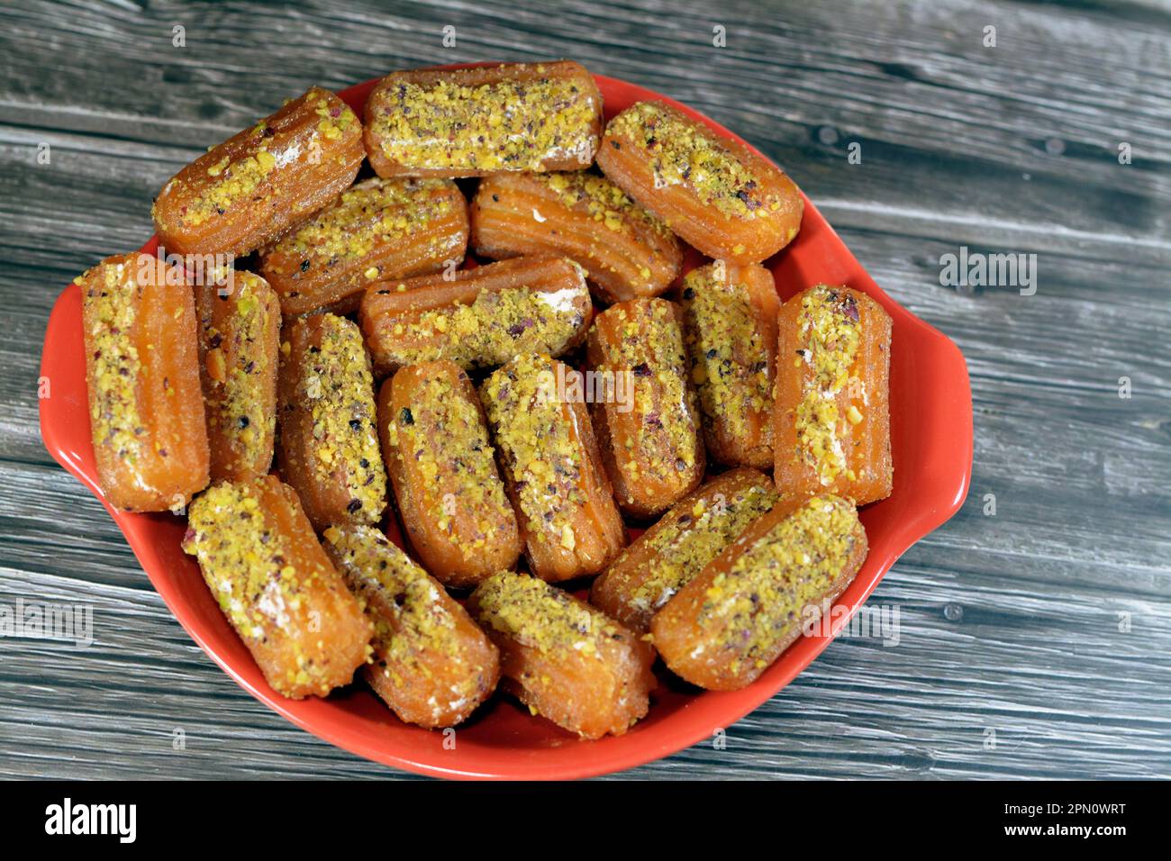 Tulumba, Bamiyeh or Balah El Sham stuffued with whipped cream and ...