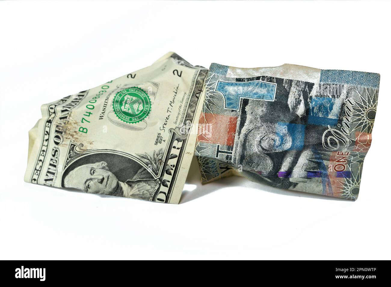 Wrinkled and crumpled Kuwaiti 1 KWD one dinar bill banknote and 1 one ...