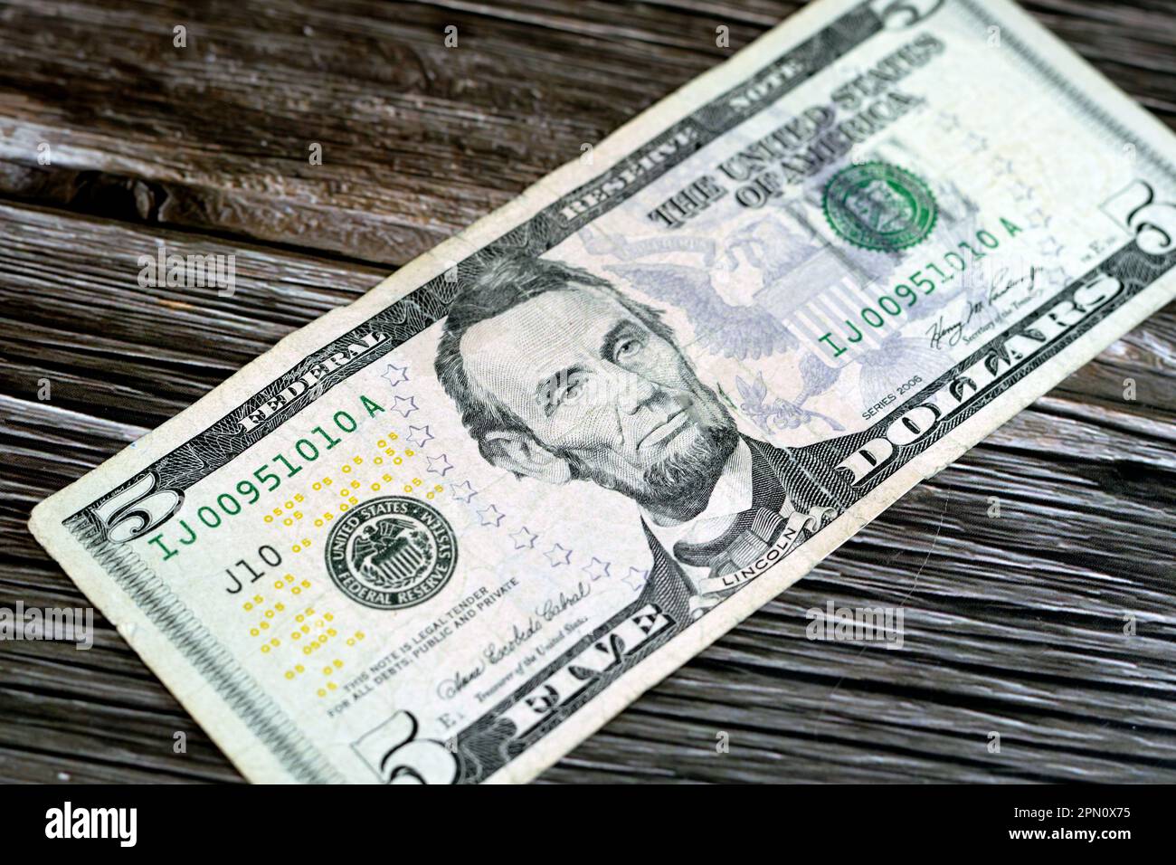 Obverse side of a torn 5 five dollars bill banknote repaired with ...