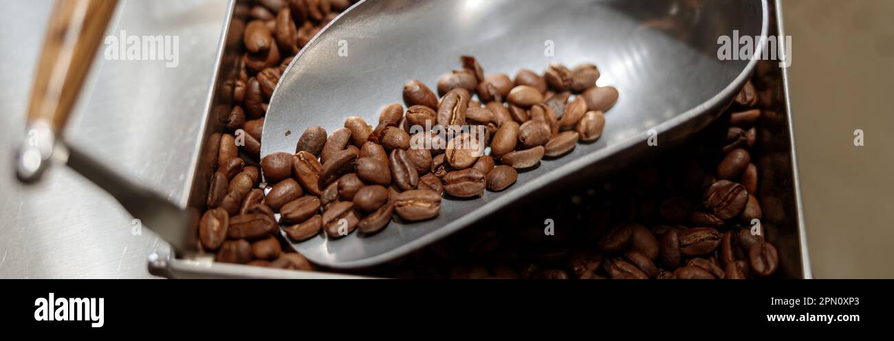 Container and scoop with roasted coffee beans Stock Photo - Alamy