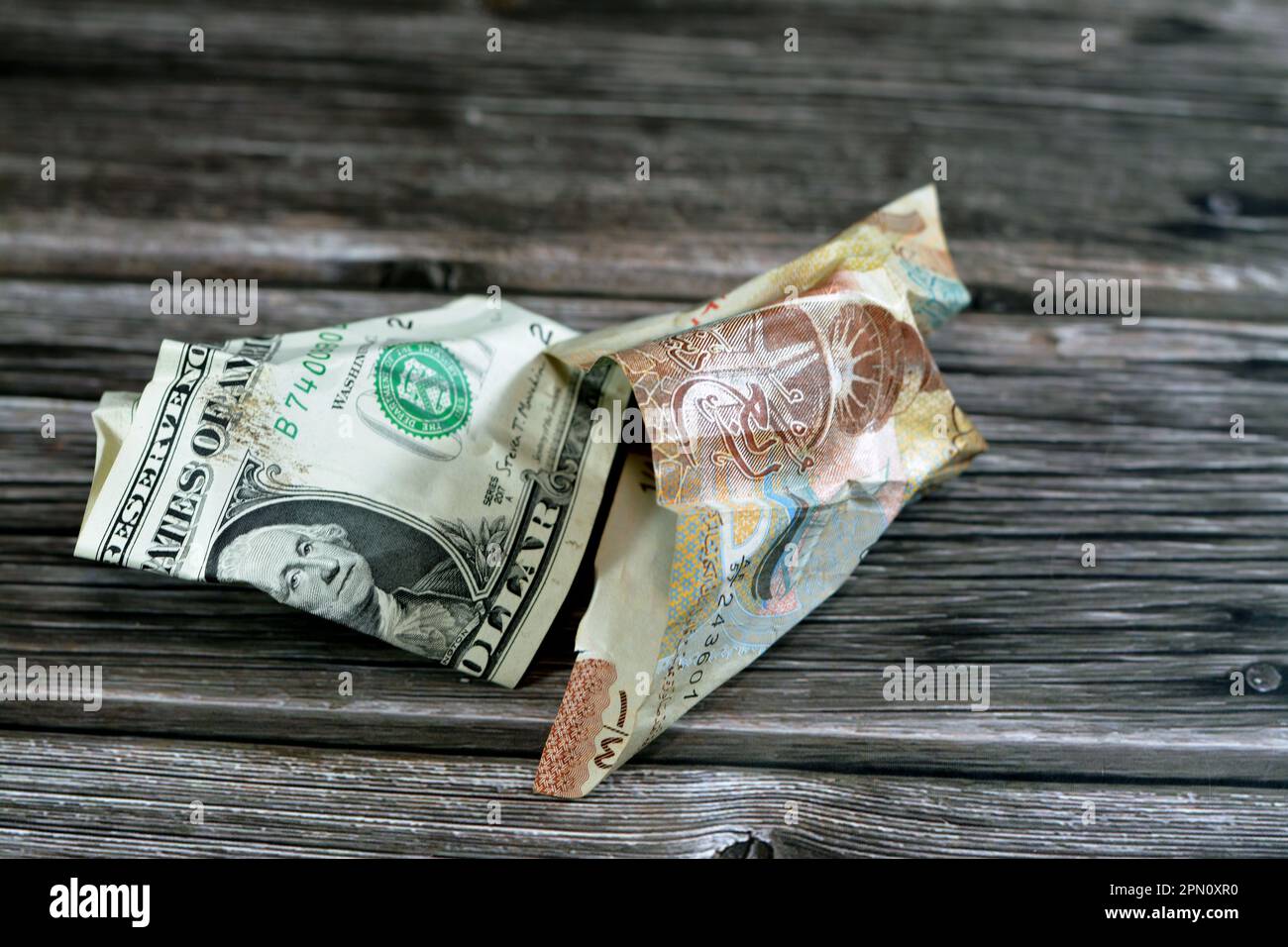 Money inflation and losing value, drop concept, Crumpled Kuwaiti money ...