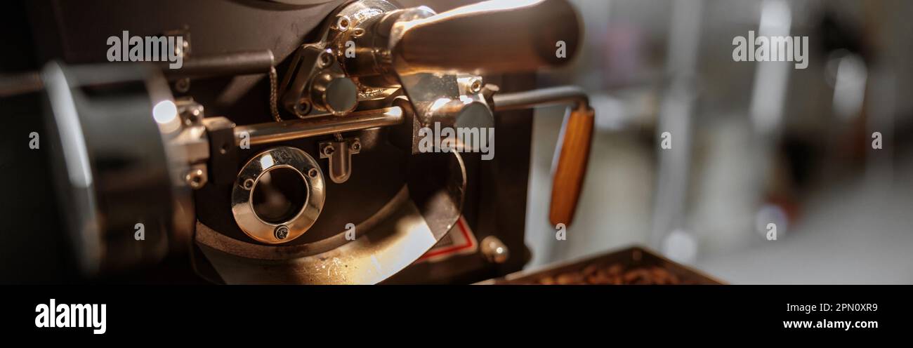 Industrial coffee roasting machine with brown coffee beans Stock Photo ...
