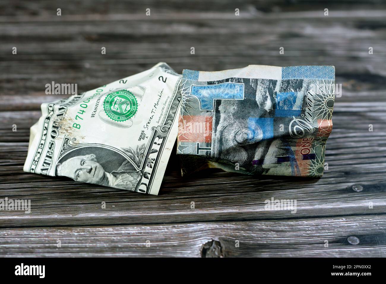 Wrinkled and crumpled Kuwaiti 1 KWD one dinar bill banknote and 1 one ...