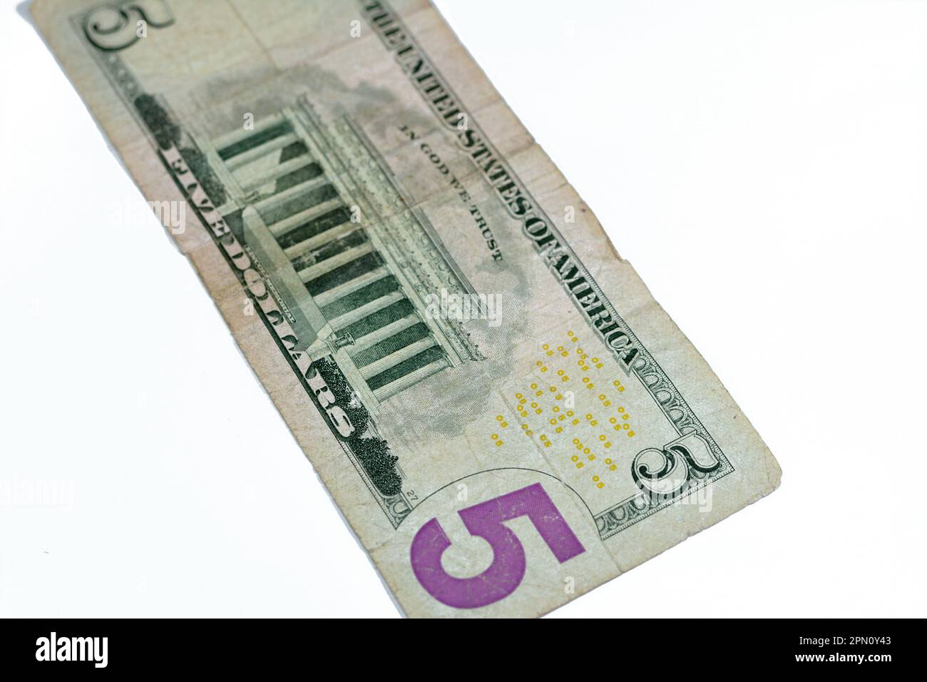 Reverse side of a torn 5 five dollars bill banknote repaired with ...