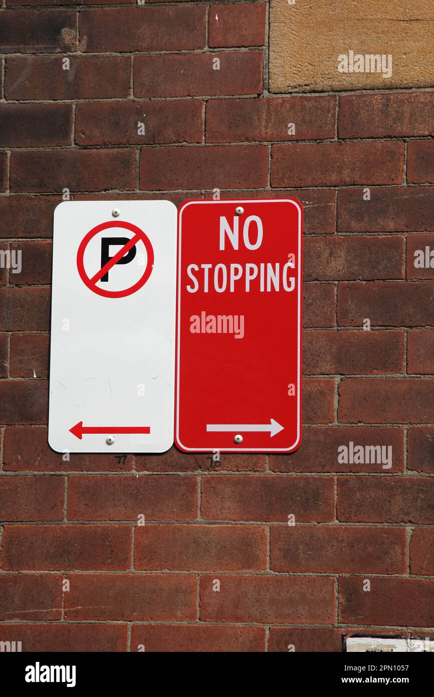 Parking restriction signs on a old brick wall Stock Photo - Alamy
