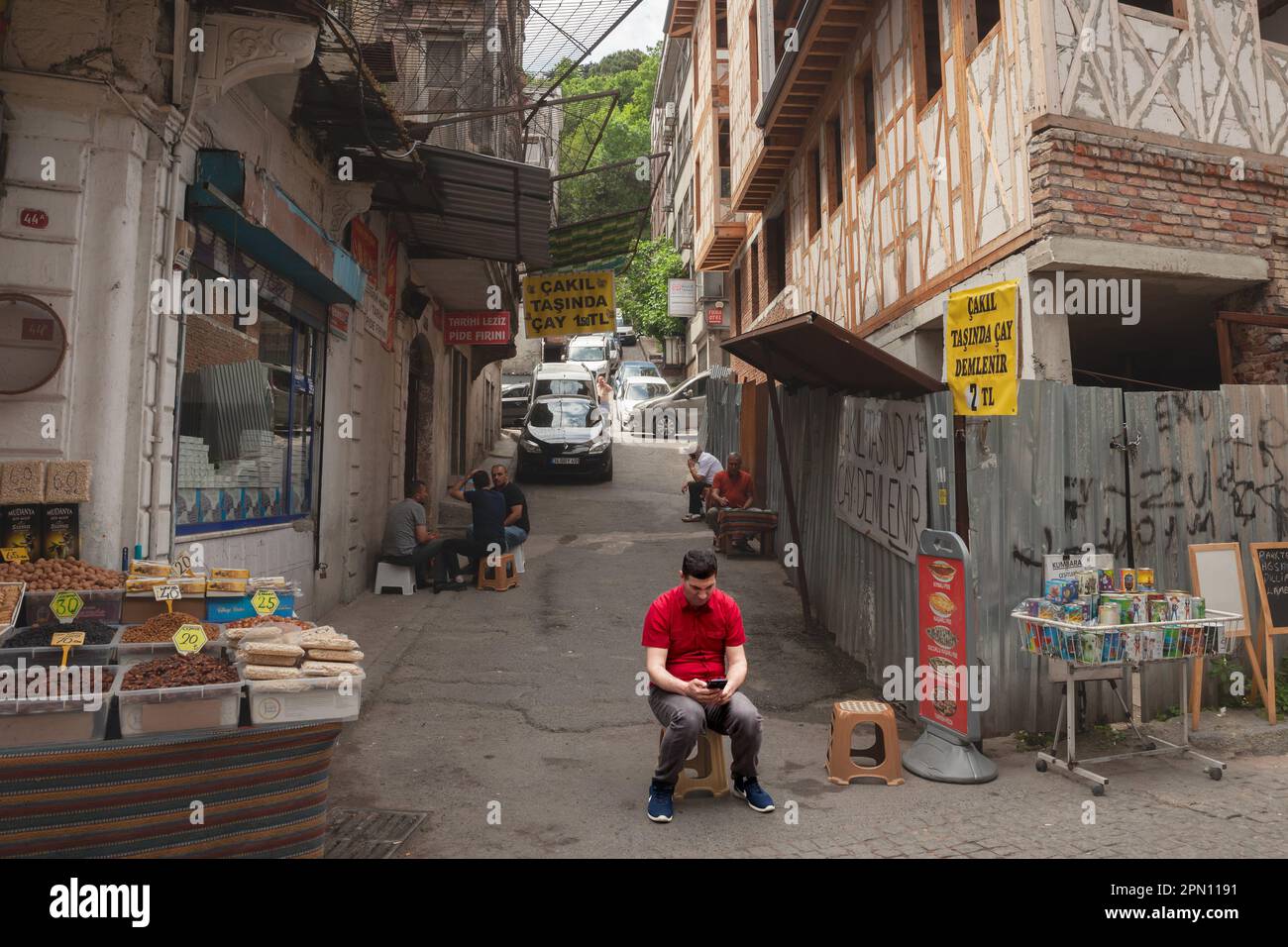 Picture of a young man sitting in front of a street in Istanbul, Turkey ...