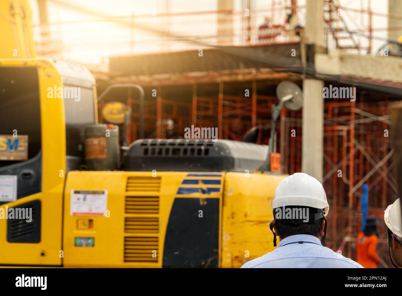 Civil engineer and teamwork inspect construction site of housing ...