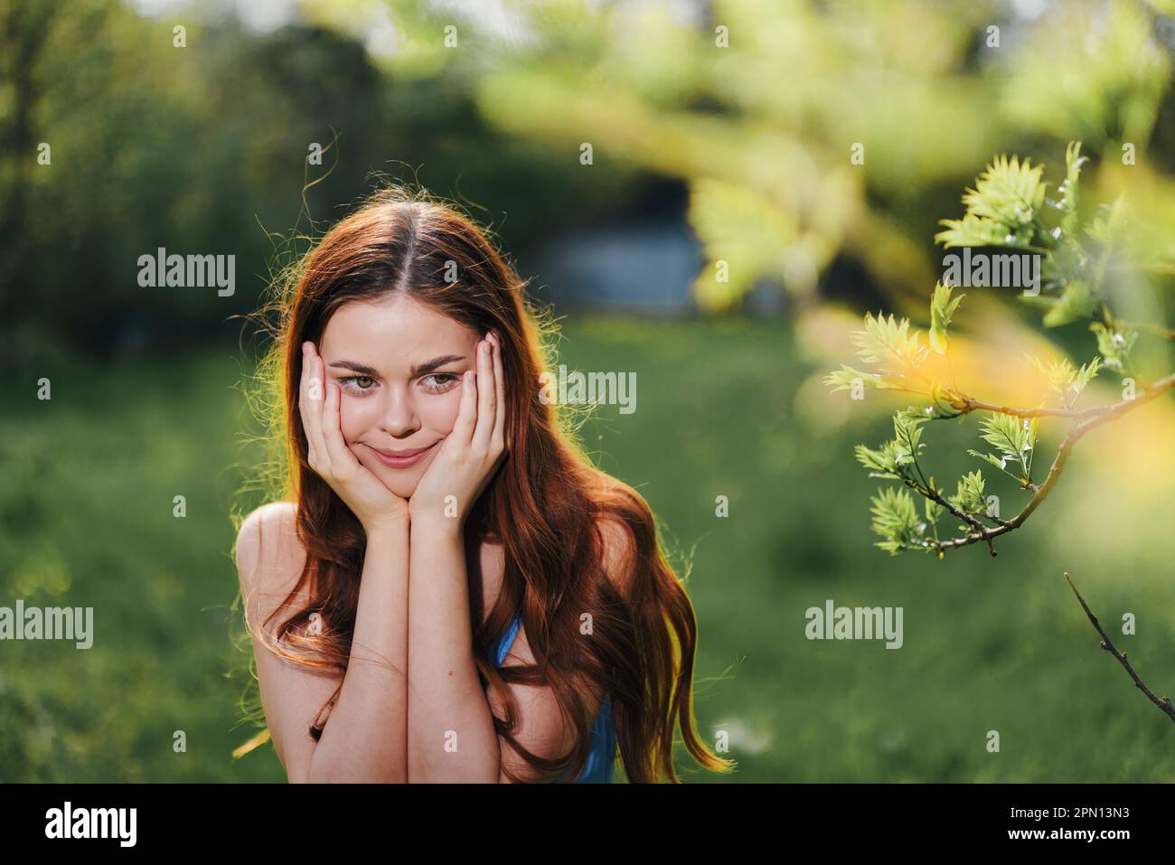 Woman beautiful smile with teeth in the spring on a sunny day happy in ...