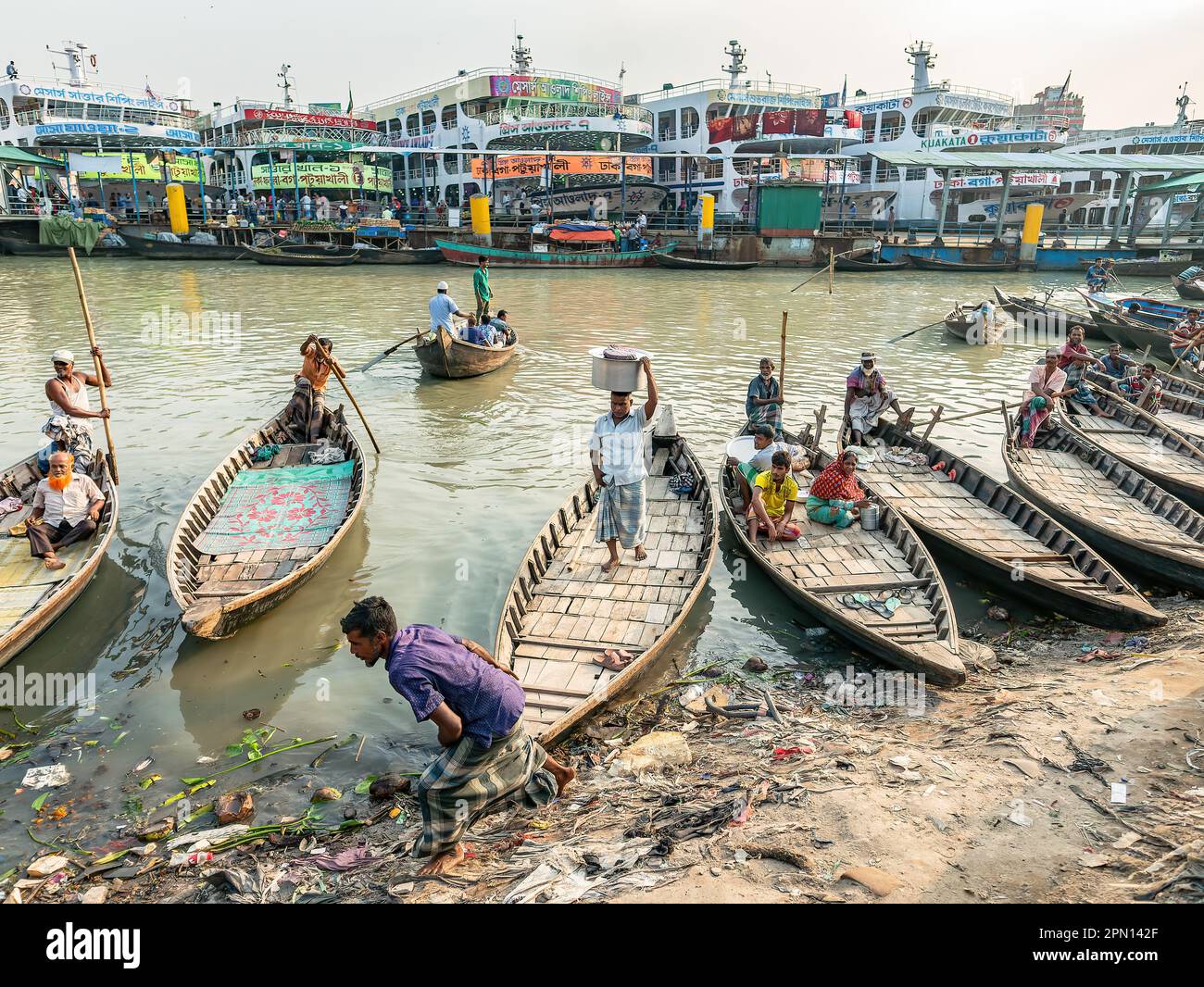 Ferries of different sizes at Wise Ghat Boat Station on Buriganga River ...