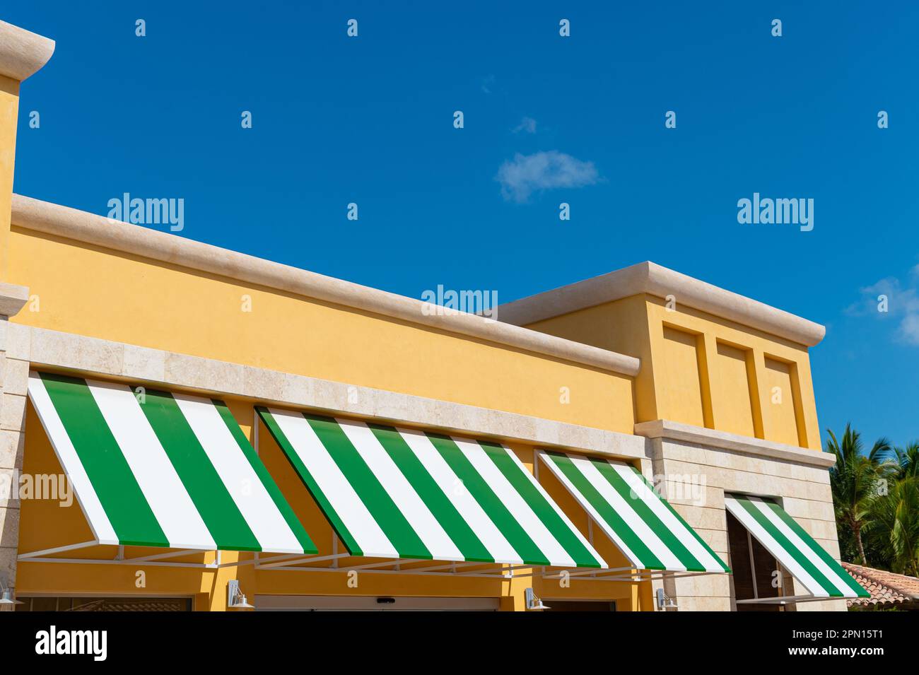 sunblind awning on the building. striped sunblind awning. sunblind ...