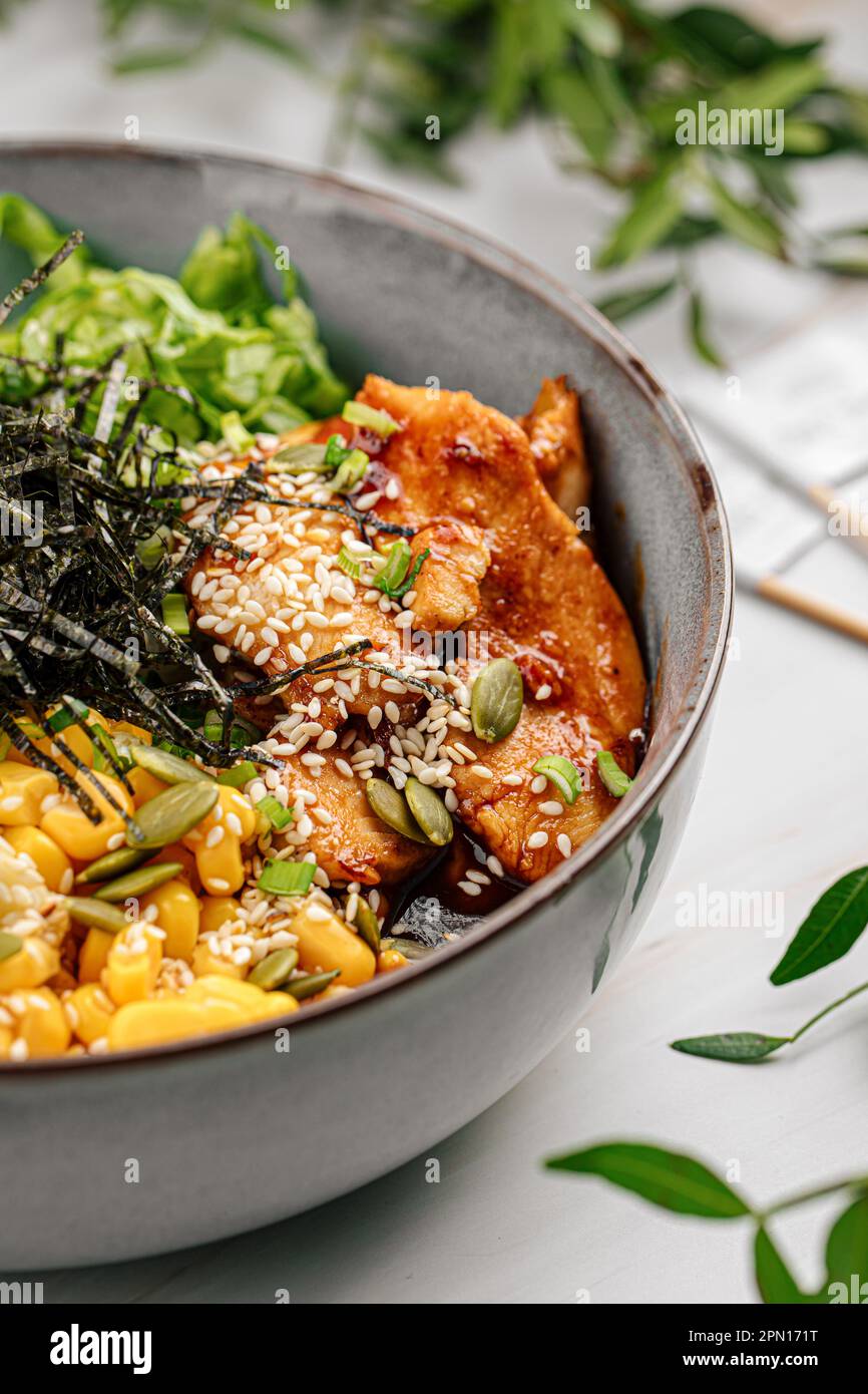 Portion of fried chicken poke bowl with vegetables Stock Photo - Alamy