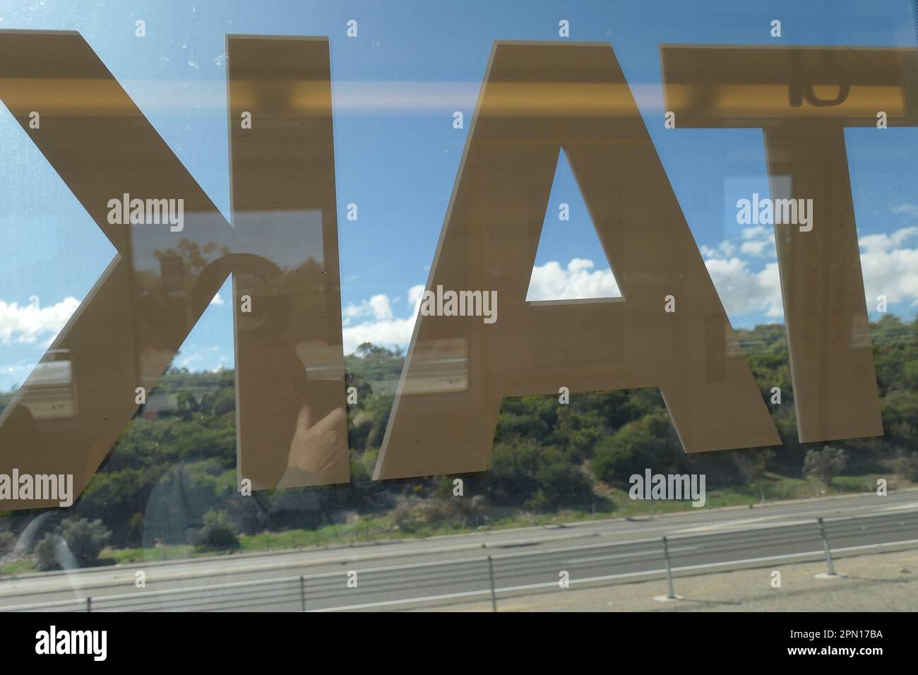 Closeup of large letters on outside window of a train giving a message ...