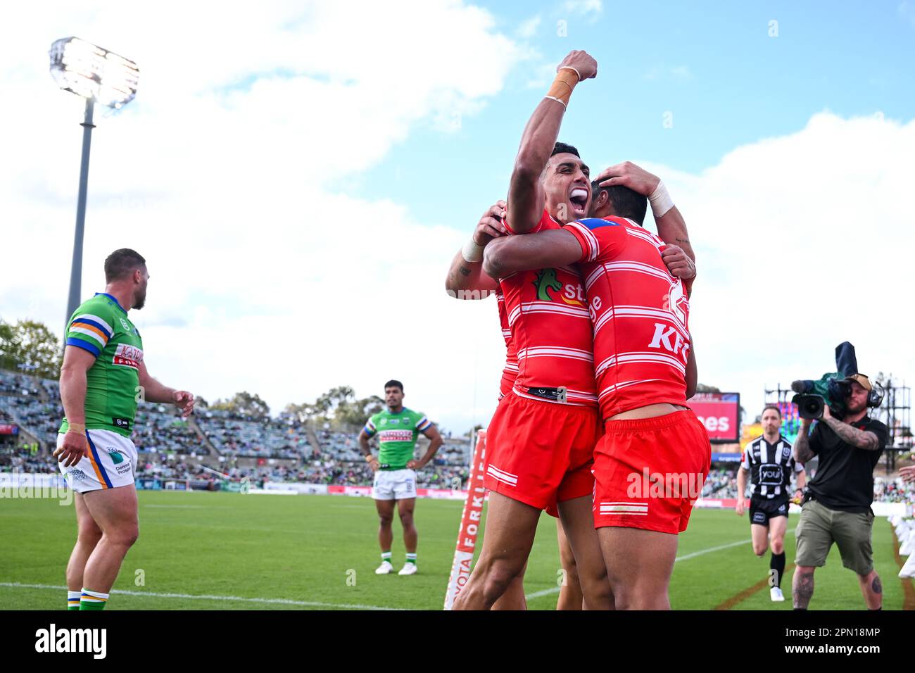 Mathew Feagai of the Dragons celebrates with team mates after scoring a ...
