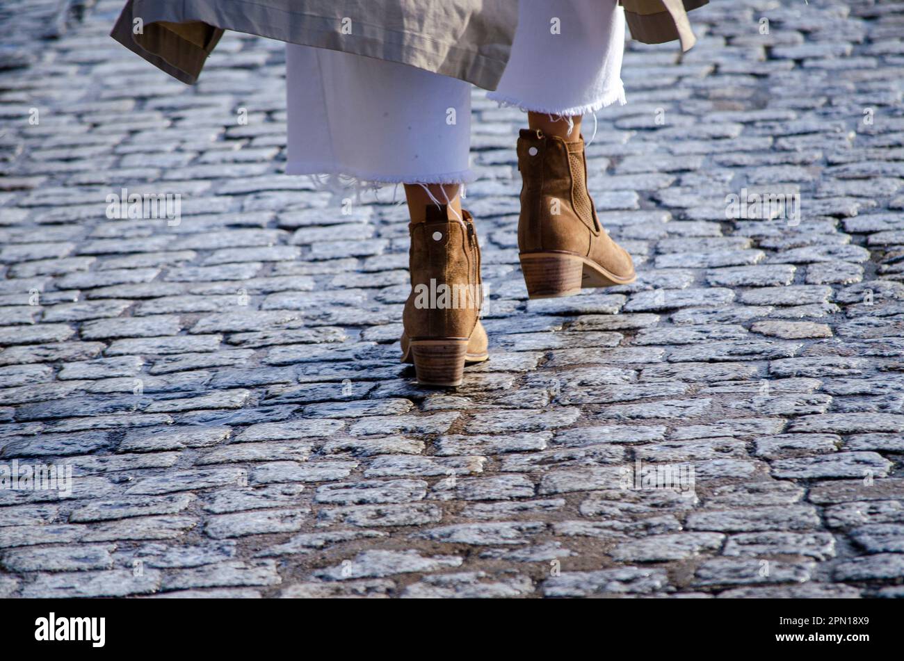 feet of a woman walking in boots Stock Photo - Alamy