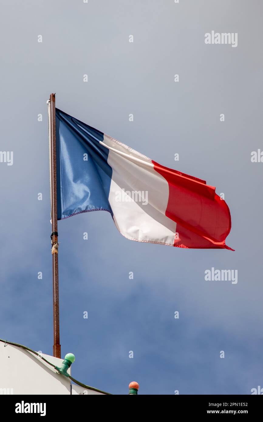 Flag of France waving over cloud blue french sky Stock Photo - Alamy