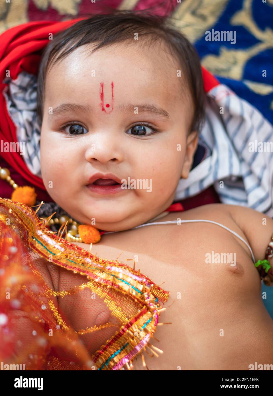 Cute Indian Boy Dresses As Lord Rama With Bow And Flowers From Top cute-indian-boy-dresses-as-lord-rama-with-bow-and-flowers-from-top