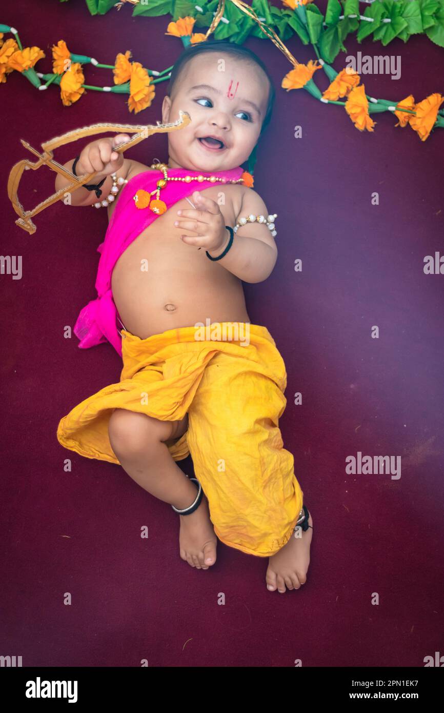 cute Indian boy dresses as lord rama with bow and flowers from top ...