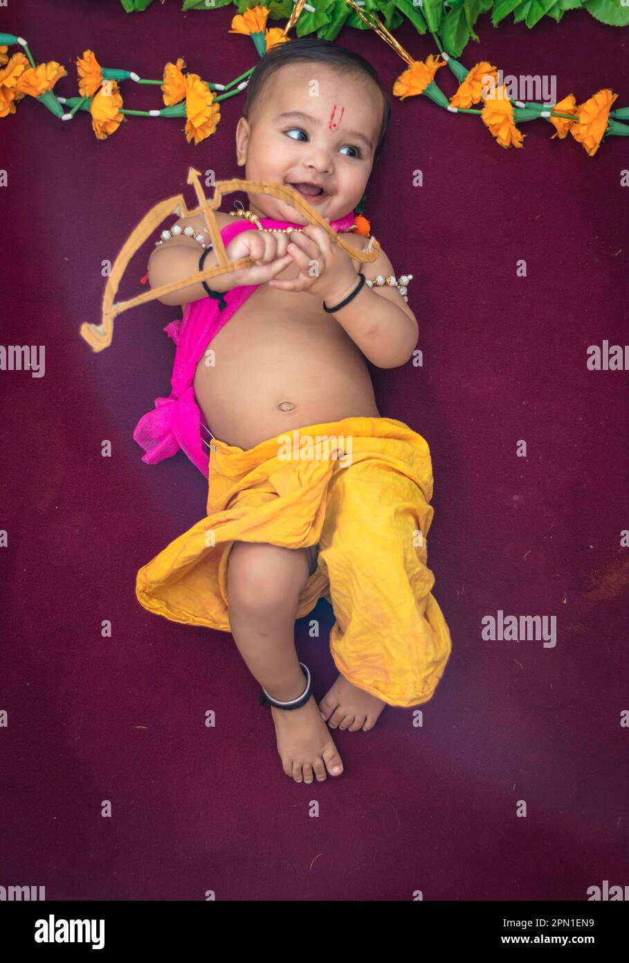 cute Indian boy dresses as lord rama with bow and flowers from top ...