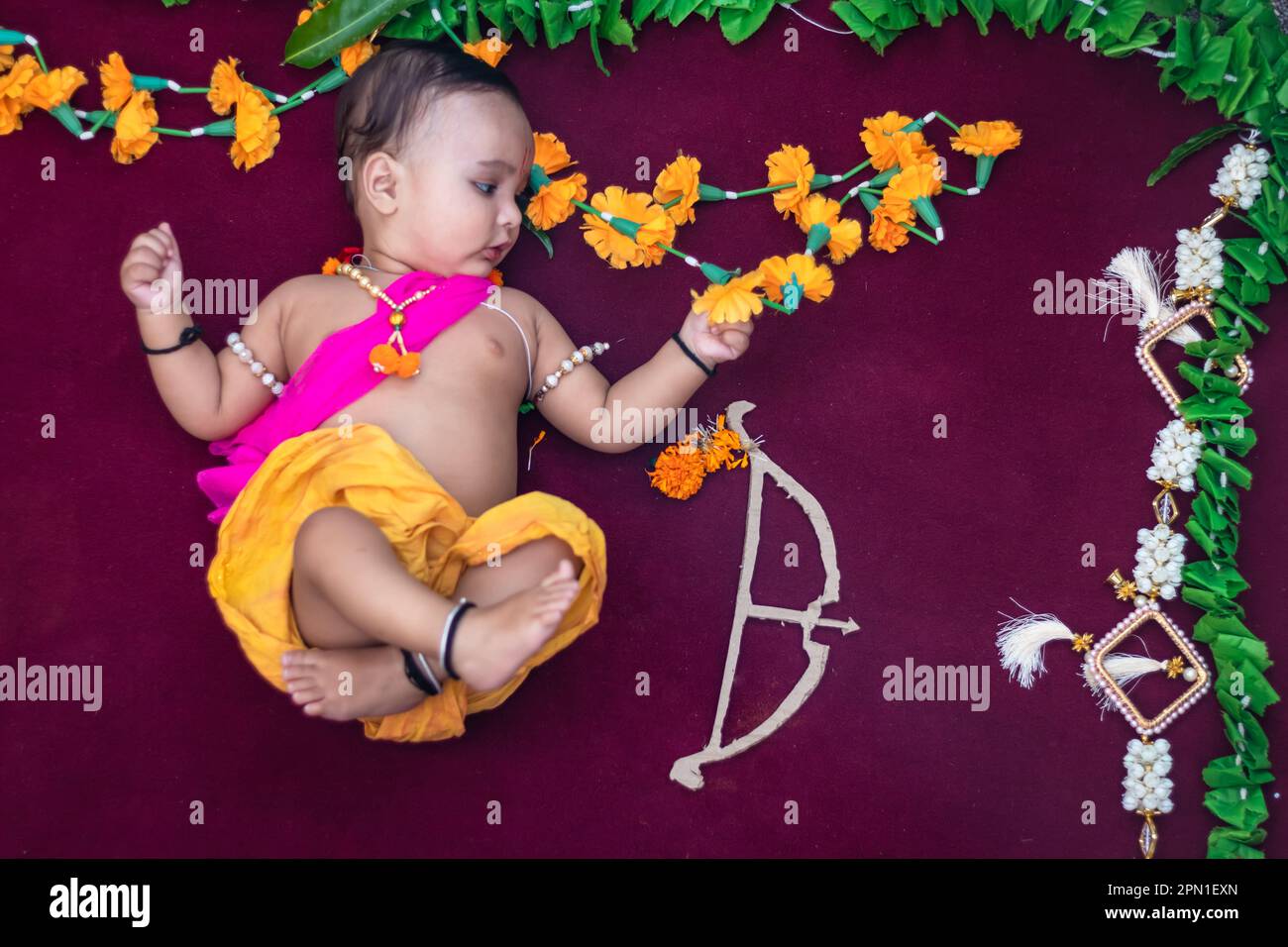 cute Indian boy dresses as lord rama with bow and flowers from top ...