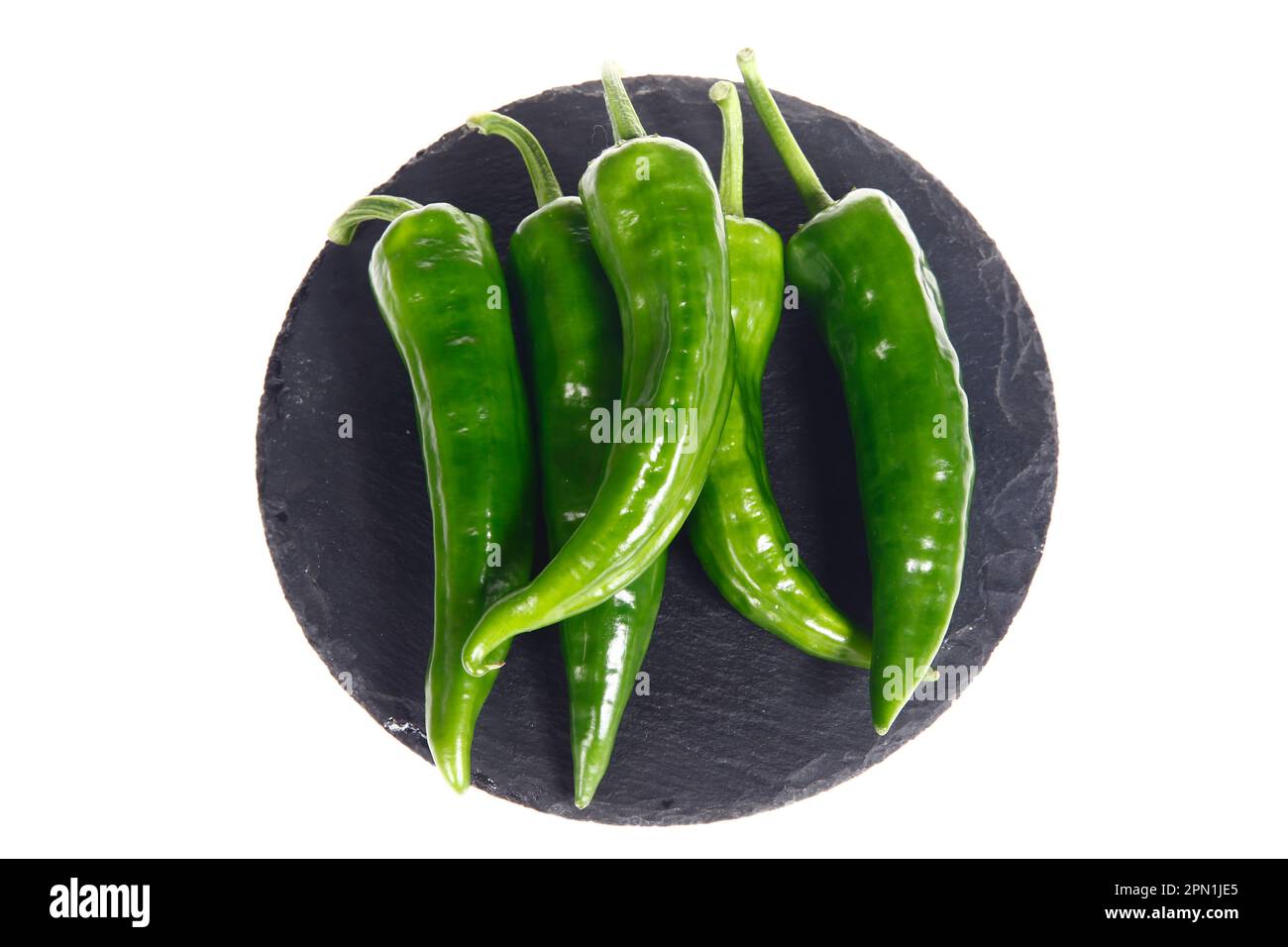 Fresh green chilies on white background Stock Photo - Alamy
