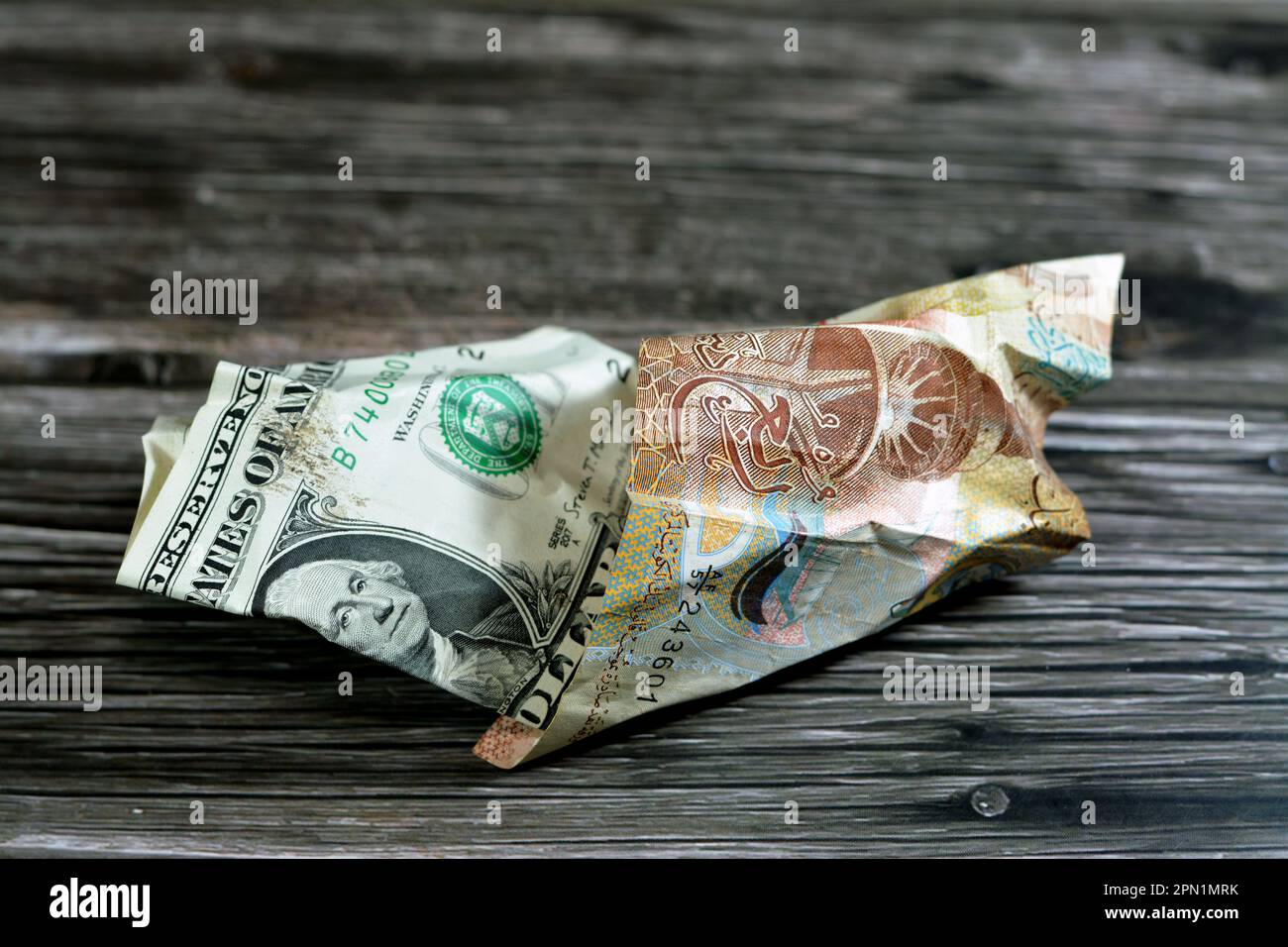 Money inflation and losing value, drop concept, Crumpled Kuwaiti money ...