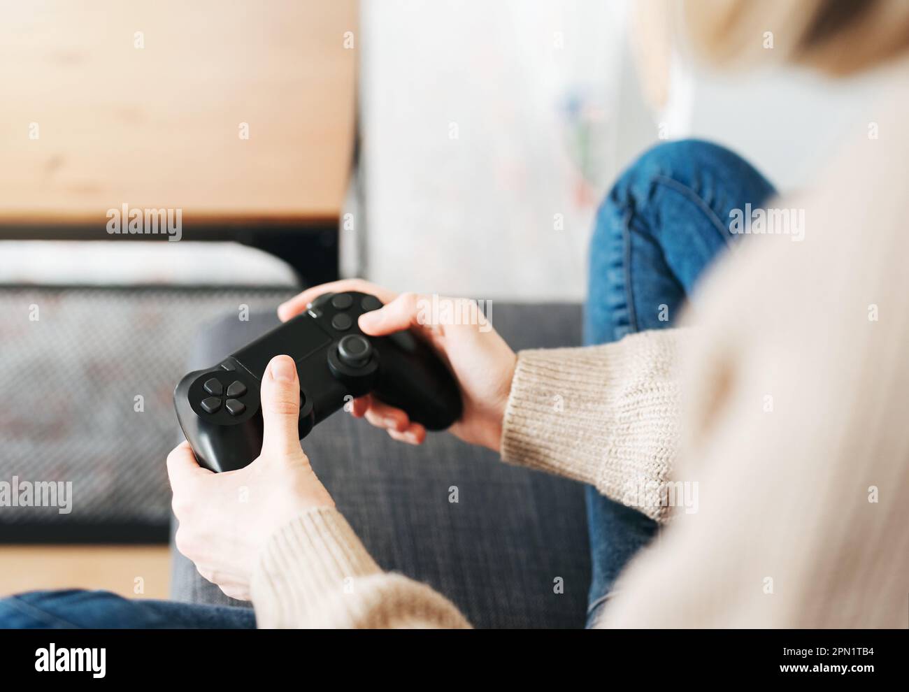 A girl holding game controller playing video games Stock Photo - Alamy