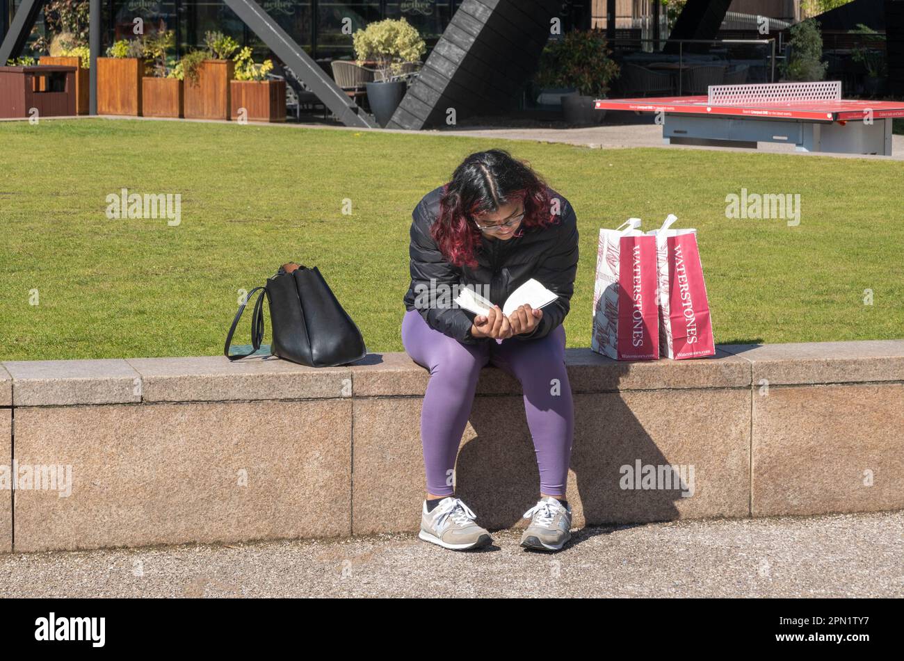Young woman reading in Liverpool Stock Photo - Alamy