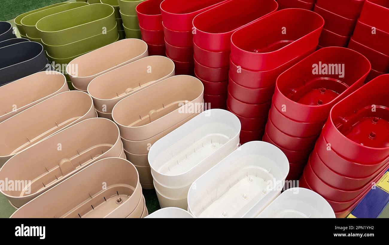 Close-up of empty flower pots in a store or greenhouse. Colorful pots ...