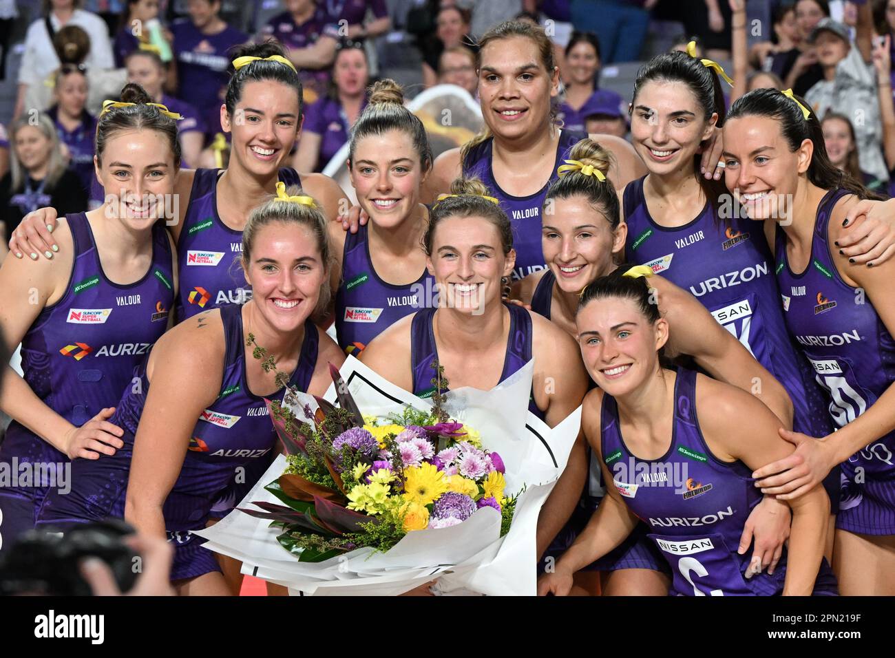 Gabi Simpson (centre) of the Firebirds is seen with team mates after ...