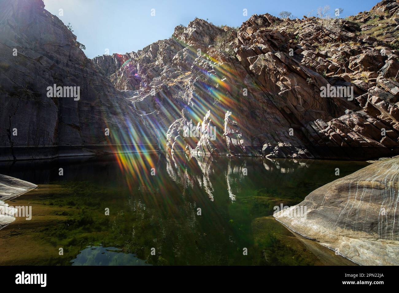 Reflections; and and spectacular lens flare in the pool beneath a dry ...