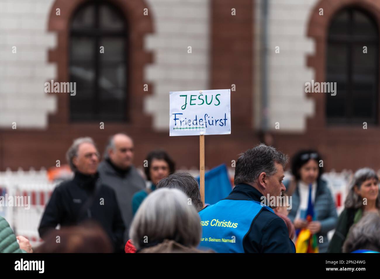 Religious protest sign above a crowd of protesers, during Easter peace ...