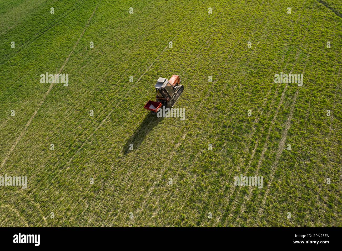 farmer driving uphill crawled tractor in the farm during spring season ...