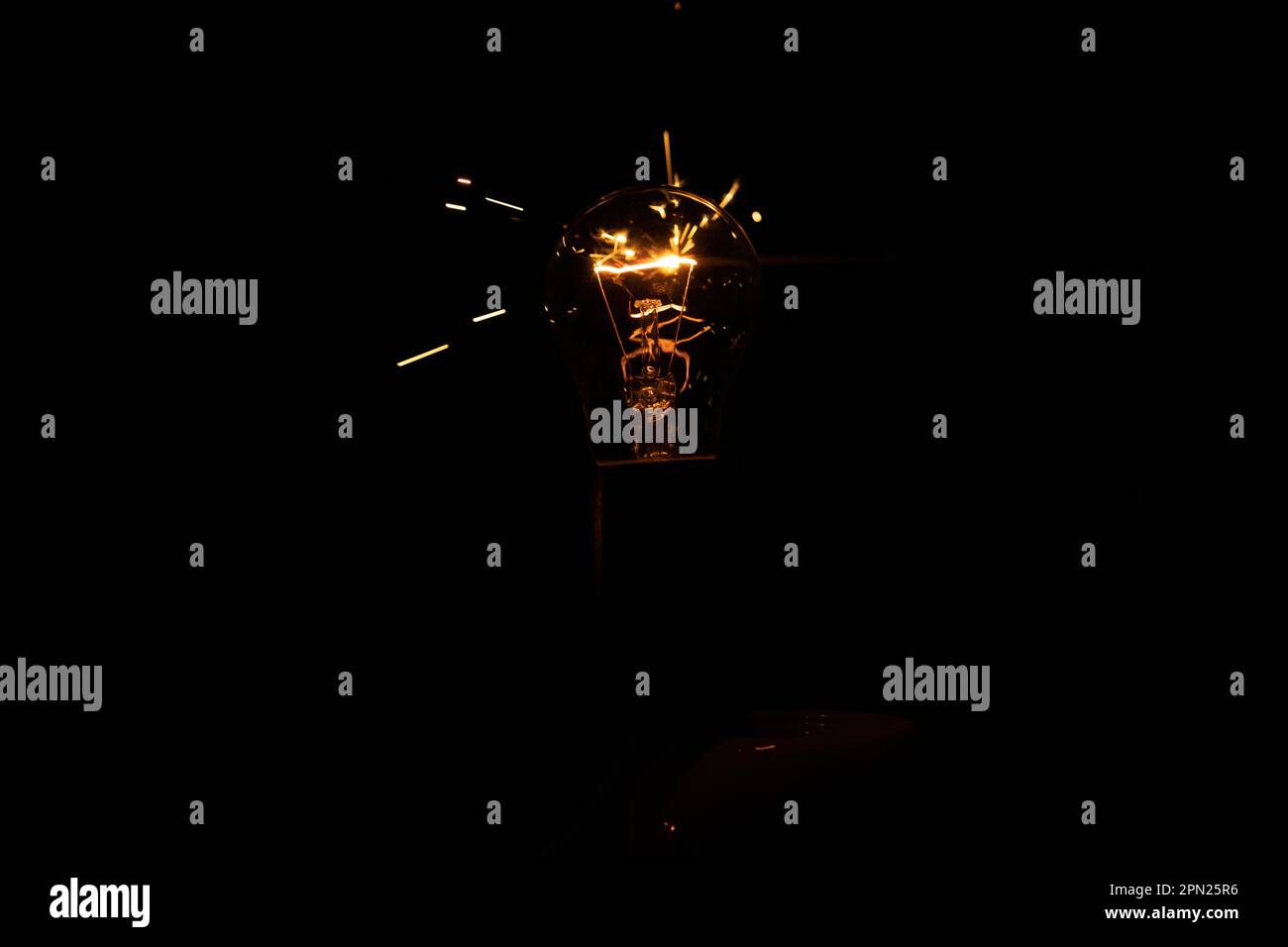 Light and sparks from a burning incandescent lamp. Short circuit Stock ...