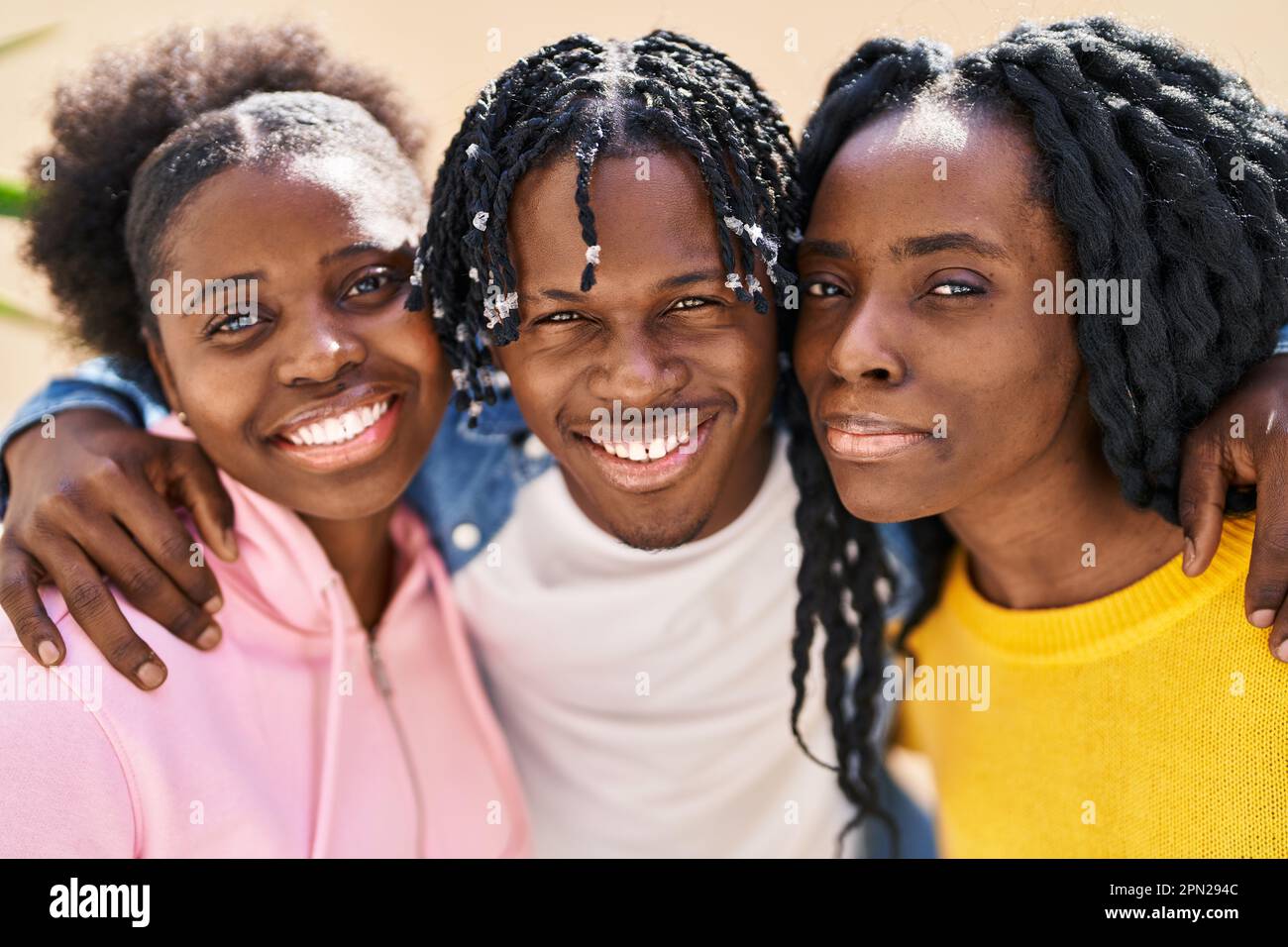 African american friends smiling confident hugging each other at street ...
