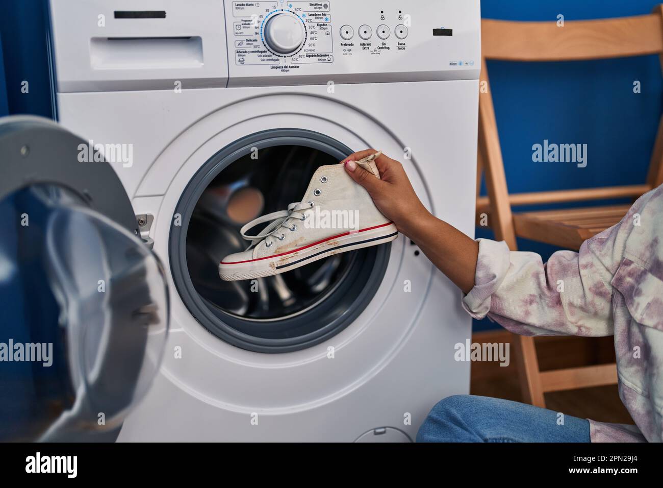 Young african american woman washing sneakers at laundry Stock Photo ...