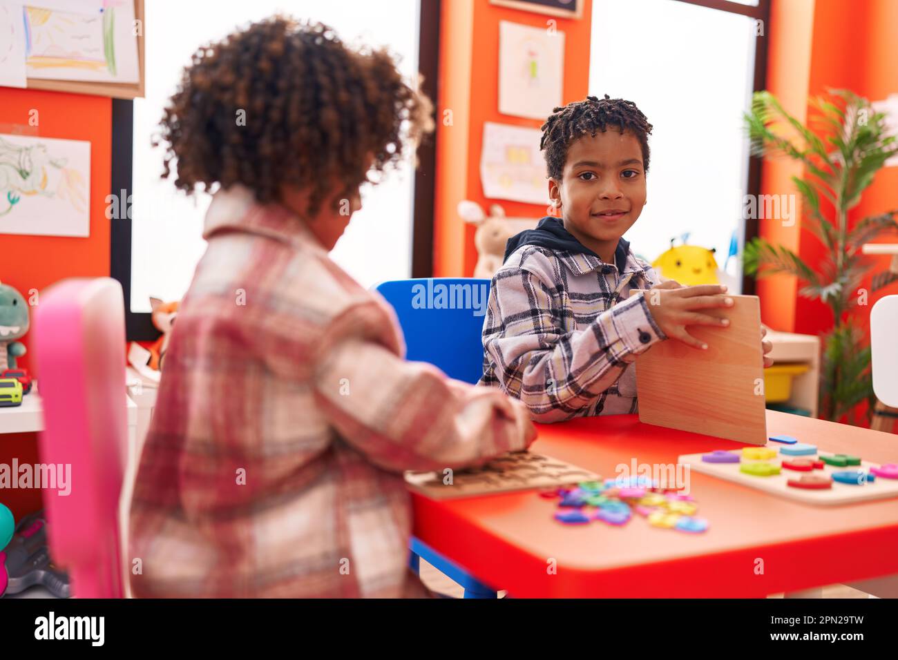 Adorable african american boy and girl playing with maths puzzle game ...