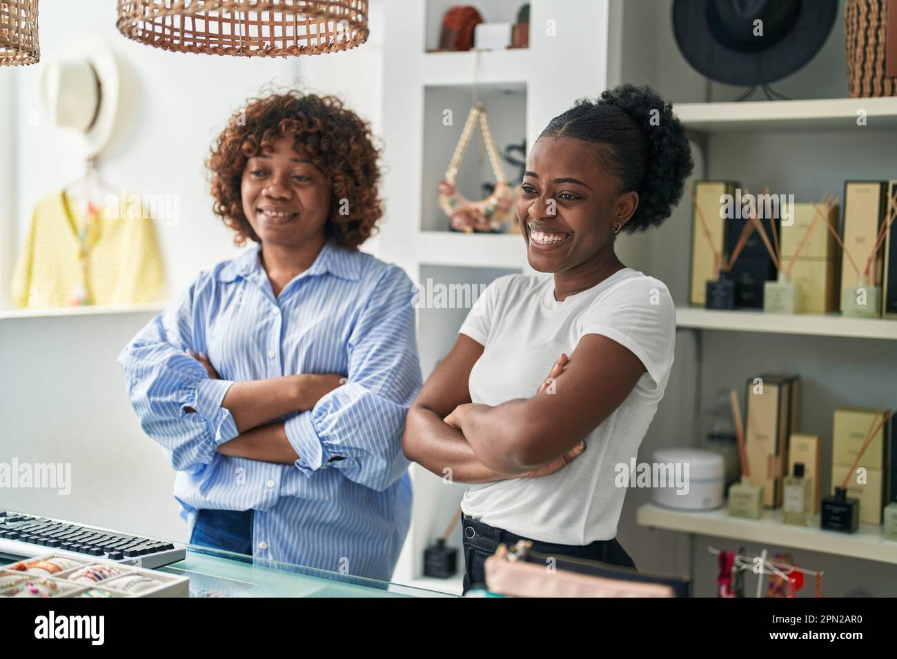 African american women shop assistants standing with arms crossed ...