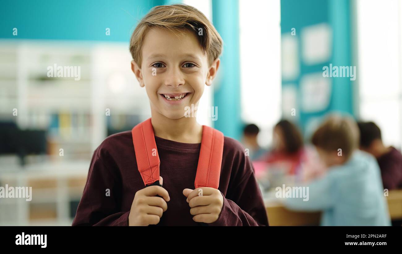 Adorable caucasian boy student smiling confident standing at classroom ...